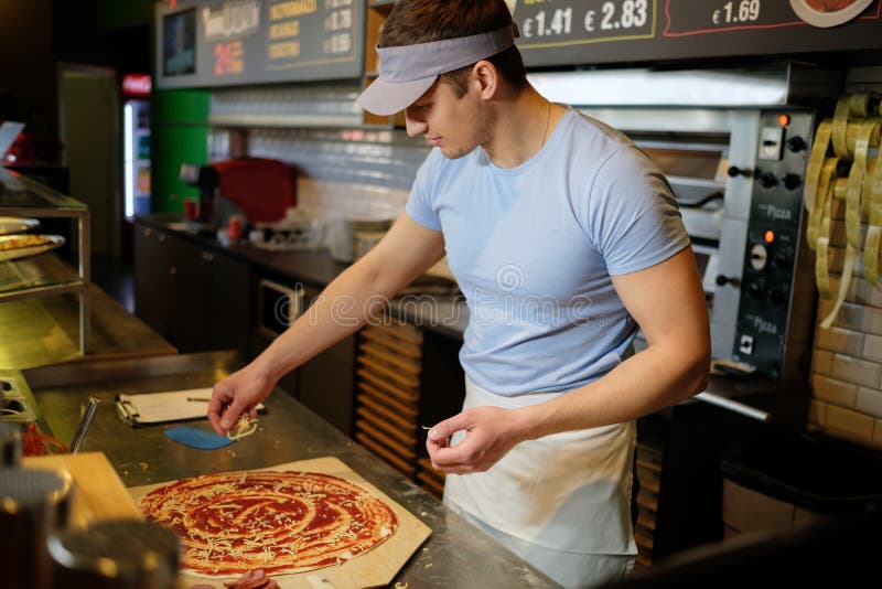 Handsome Pizzaiolo Making Pizza at Kitchen in Pizzeria. Stock Photo ...
