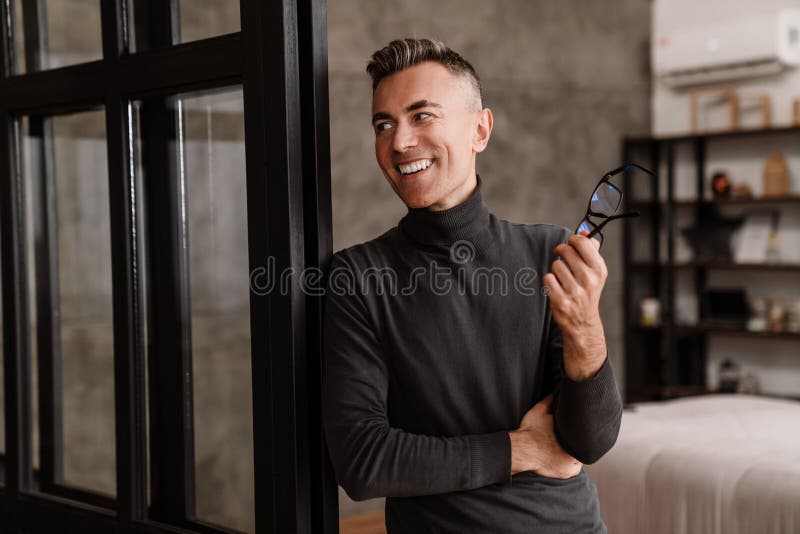 Handsome Pleased Man Laughing at Camera while Leaning on Wall Stock ...
