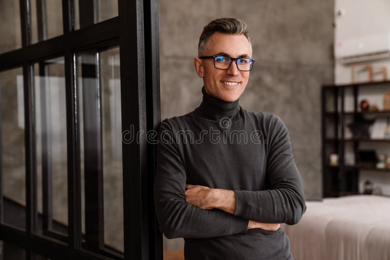 Handsome Pleased Man Smiling at Camera while Leaning on Wall Stock ...