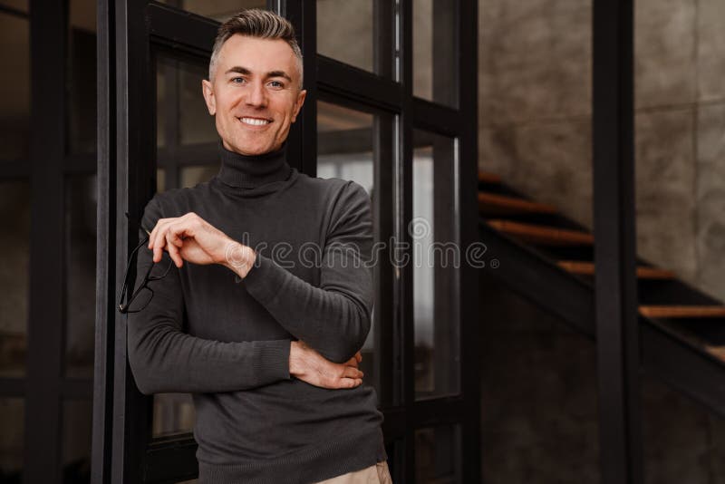 Handsome Pleased Man Smiling at Camera while Leaning on Wall Stock ...