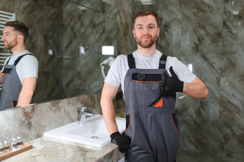 Handsome Plumber Working in Restroom Stock Photo - Image of home ...