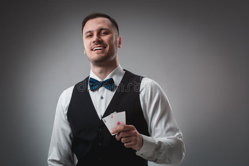 Handsome Poker Player with Two Aces in His Hands and Chips Sitting at ...