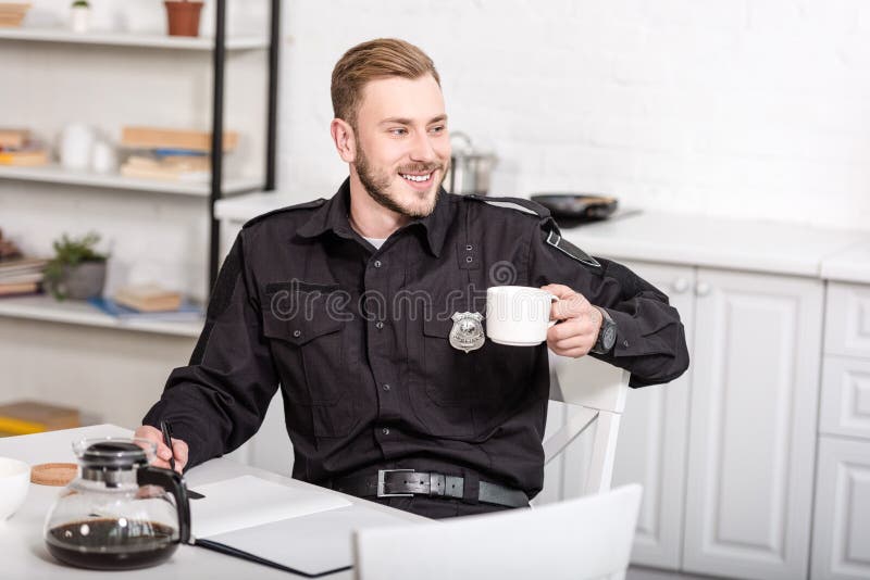 Handsome Police Officer Sitting at Kitchen Table, Smiling and Stock ...