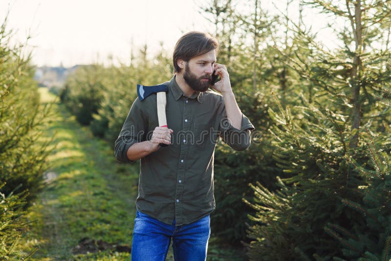Handsome Positive Bearded Man with Ax Which Walking among the Christmas ...