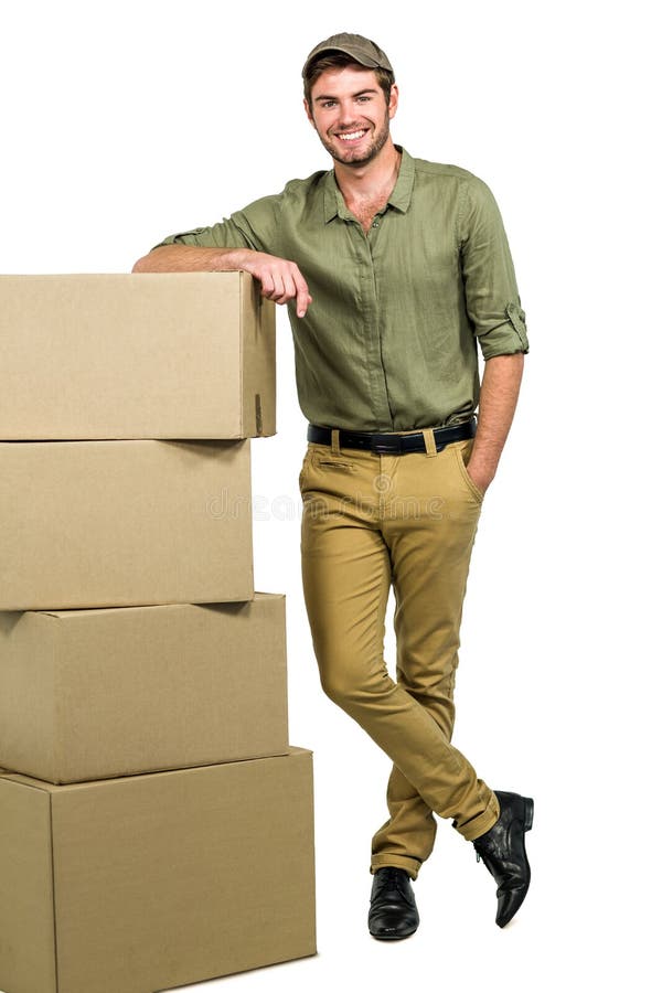Handsome Postman Standing by Cardboard Boxes Stock Photo - Image of ...