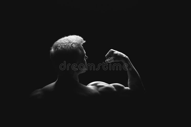 Handsome Power Athletic Man in Dramatic Light. Strong Bodybuilder with ...