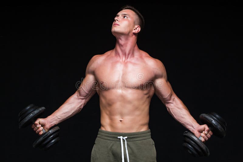 Handsome Power Athletic Man with Dumbbell Confidently Looking Forward ...