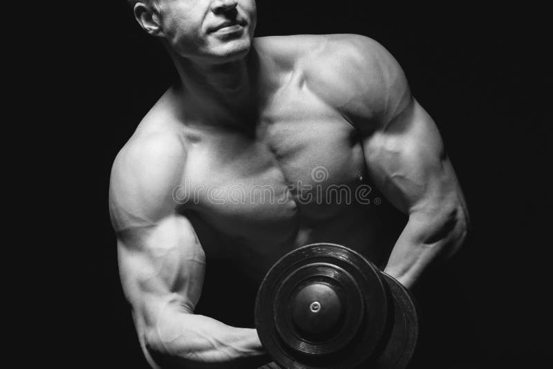 Handsome Power Athletic Man with Dumbbell Confidently Looking Forward ...