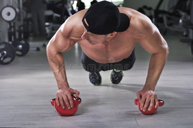 Handsome Powerful Athletic Man Performing Push Ups with Kettle Bell ...