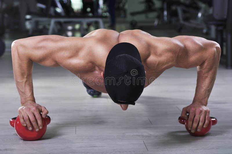 Handsome Powerful Athletic Man Performing Push Ups With Kettle Bell ...