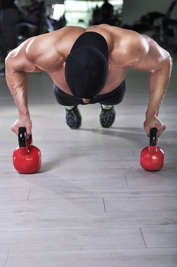 Handsome Powerful Athletic Man Performing Push Ups with Kettle Bell ...