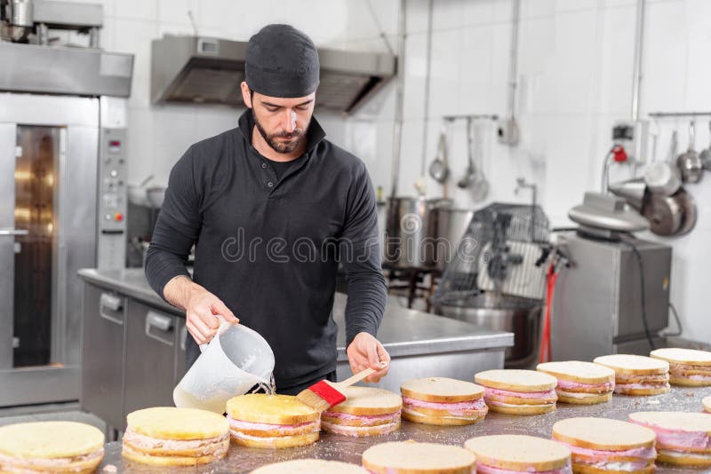 Handsome Professional Confectioner Making a Batch of Delicious Cake in ...