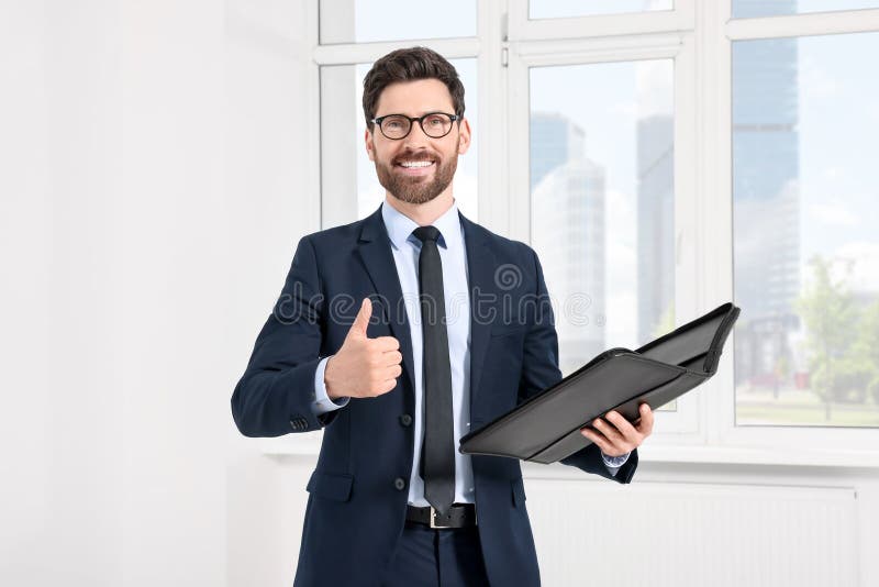 Handsome Real Estate Agent with Documents Showing Thumbs Up Indoors ...