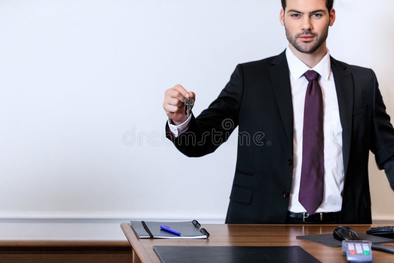 Handsome Receptionist Standing at Reception Desk Stock Photo - Image of ...
