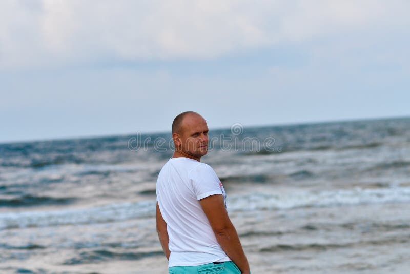 Relaxed Young Man Standing on the Beach Stock Photo - Image of ... Relaxed Young Man Standing on the Beach Stock Photo - Image of ...