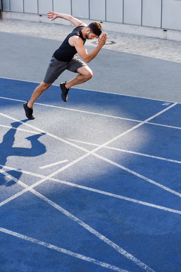 Handsome Runner Exercising on Running Track Stock Photo - Image of ...