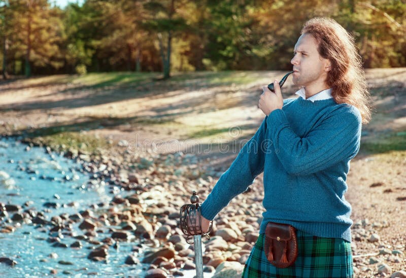 Handsome Scottish Man with Sword and Pipe Stock Image - Image of scot ...