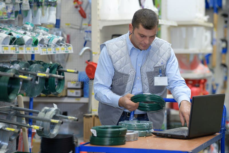 Handsome Seller Using Laptop in Hardware Store Stock Image - Image of ...