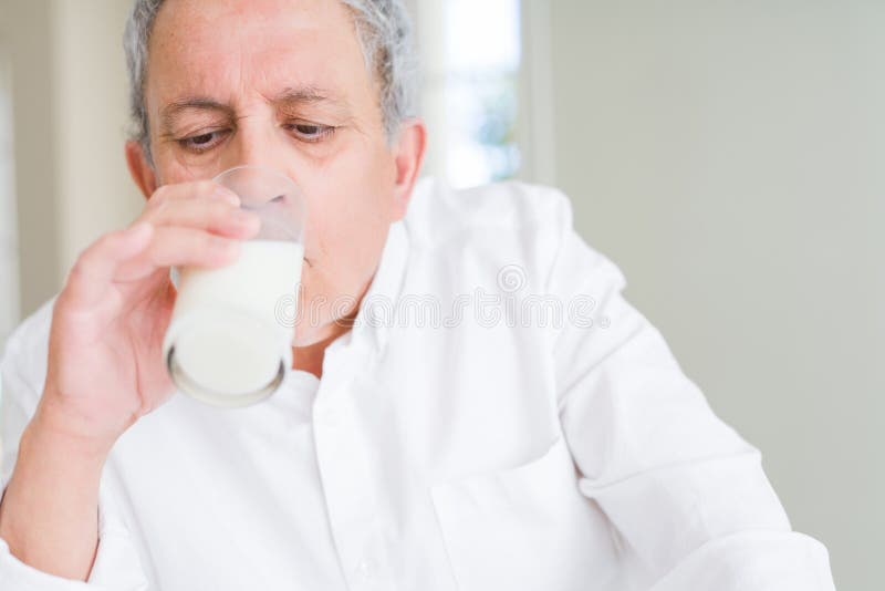Handsome Senior Man Drinking a Glass of Fresh Milk in the Morning Stock ...