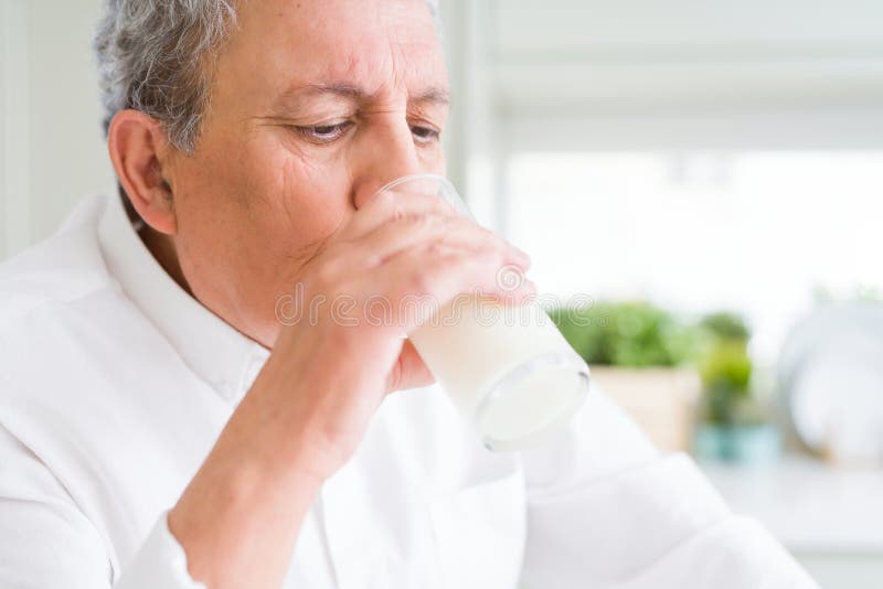 Handsome Senior Man Drinking a Glass of Fresh Milk in the Morning Stock ...