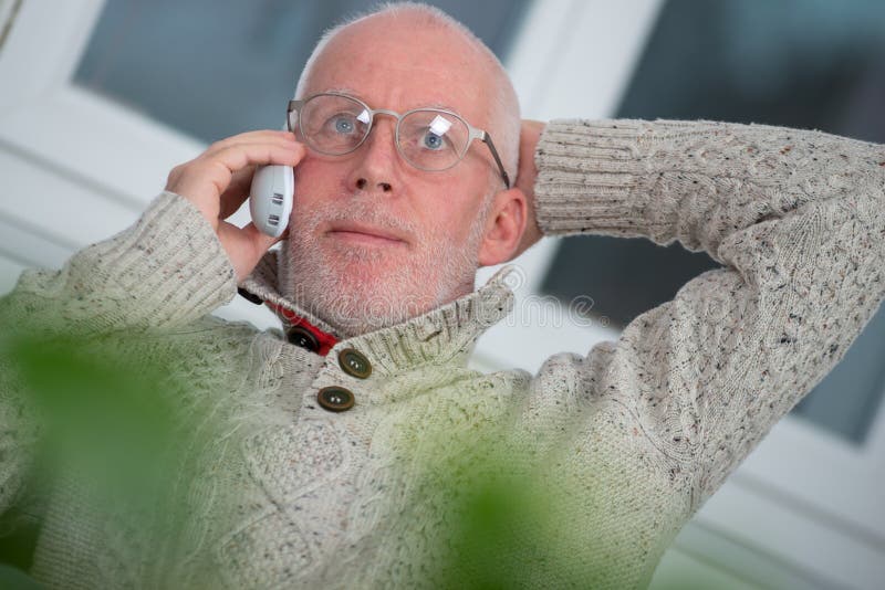 Handsome Senior Man Talking on Phone on the Sofa Stock Photo - Image of ...