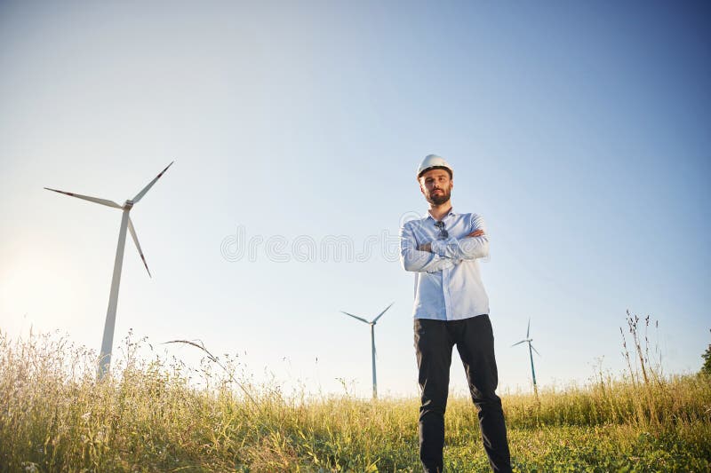 Handsome Service Engineer is Standing on the Field with Windmills Stock ...