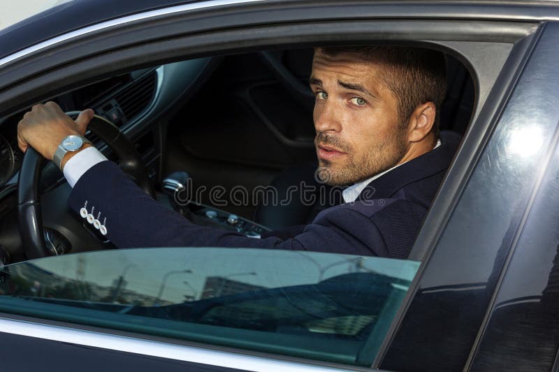 A Handsome Man in a Suit Driving a Car. Portrait Stock Photo - Image of ... A Handsome Man in a Suit Driving a Car. Portrait Stock Photo - Image of ...