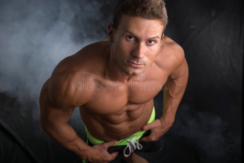 Low Angle Shot of Shirtless Male Bodybuilder on Stock Image - Image of ...