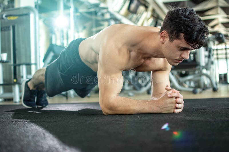 Handsome Shirtless Guy Doing Plank Exercise in Gym. Stock Image - Image ...