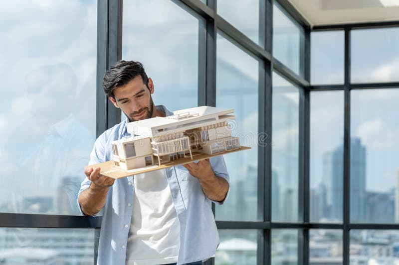 Handsome Engineer Hold Architectural Model while Inspect House Model ...