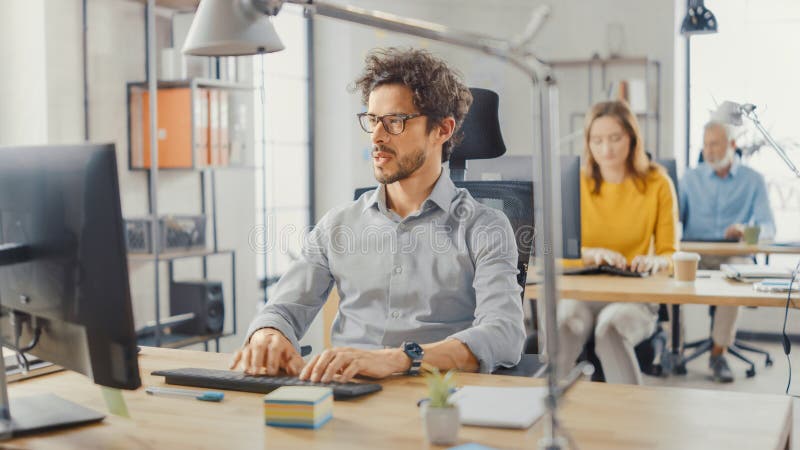 Handsome and Smart Hispanic Office Employee Sitting at His Desk Works ...