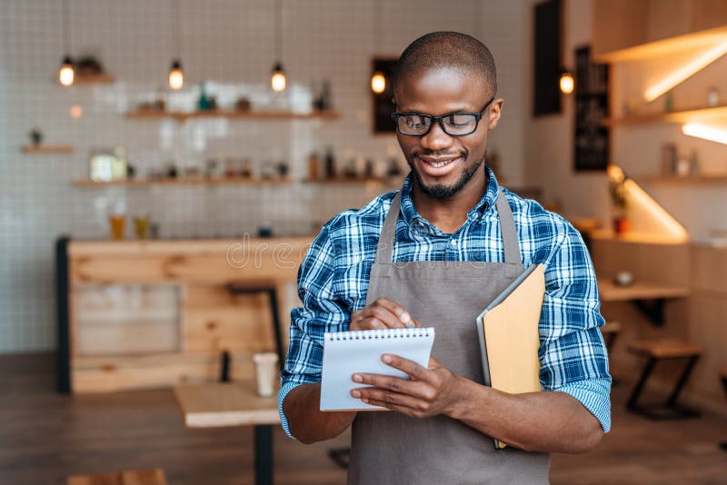 Handsome Smiling African American Waiter Taking Order With Notepad And