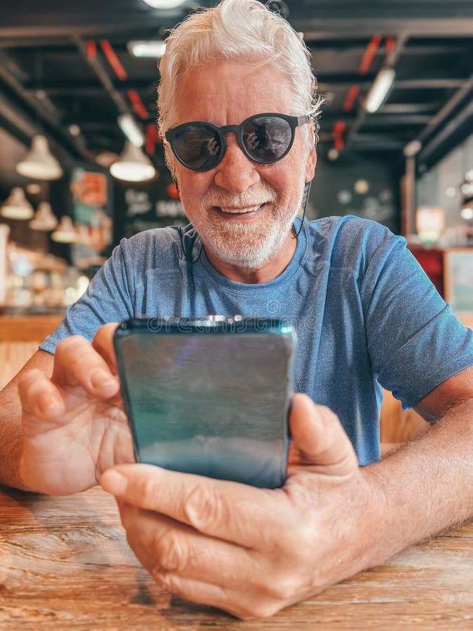 Handsome Smiling Bearded Senior Man Sitting at Cafe Table Using Mobile ...