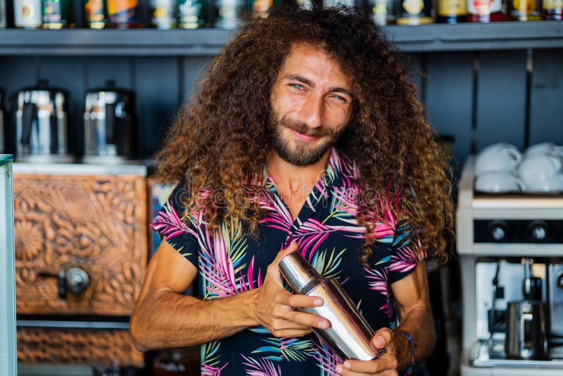 Handsome Smiling Curly Hair Bartender Preparing Cocktail at the Resort ...