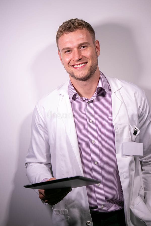 Handsome Smiling Doctor Wearing White Lab Coat, Holding Digital Tablet ...