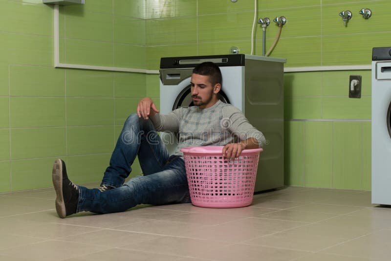 Handsome Smiling Man in the Laundry Room Stock Photo - Image of routine ...
