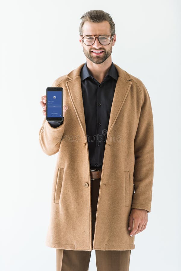 Handsome Smiling Man Presenting Smartphone with Facebook Appliance ...