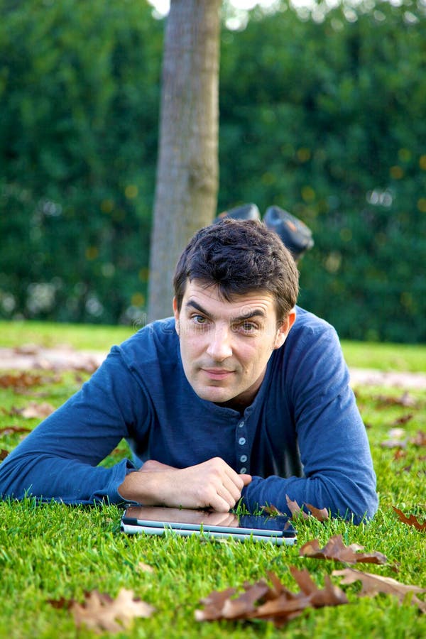 Handsome Smiling Man Reading Tablet in Park in Autumn Stock Image ...