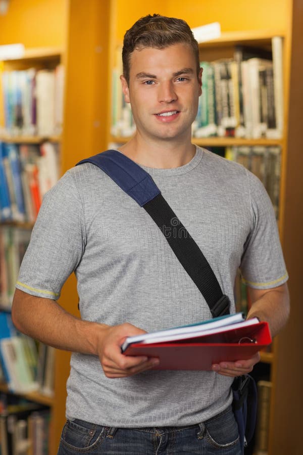 Handsome Smiling Student Holding Folder and Notebooks Stock Image ...