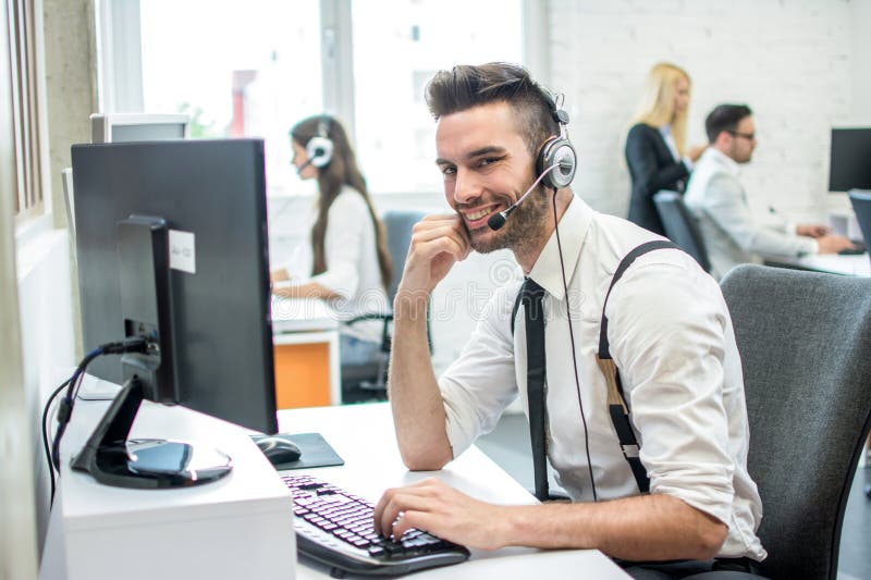 Handsome Smiling Young Call Center Agent Speaking with Costumer in Call ...