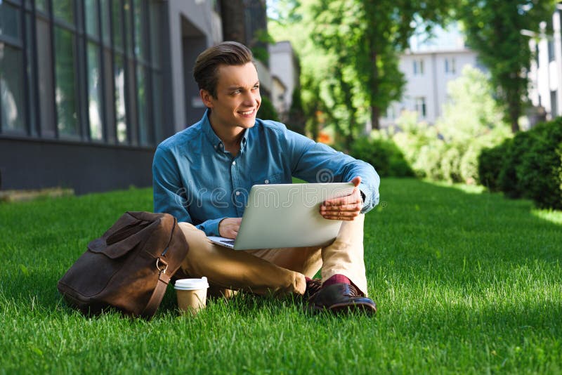 Handsome Smiling Young Freelancer Sitting on Grass Stock Image - Image ...