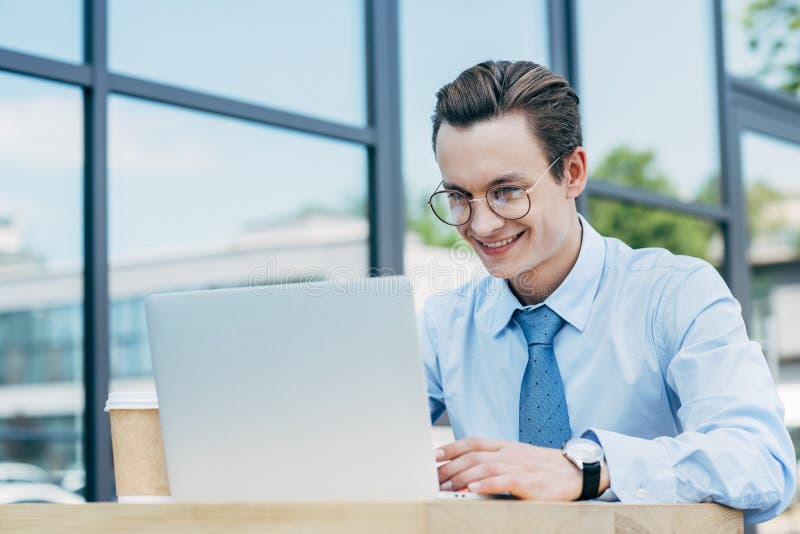 Handsome Smiling Young Man in Eyeglasses Using Laptop Outside Stock ...