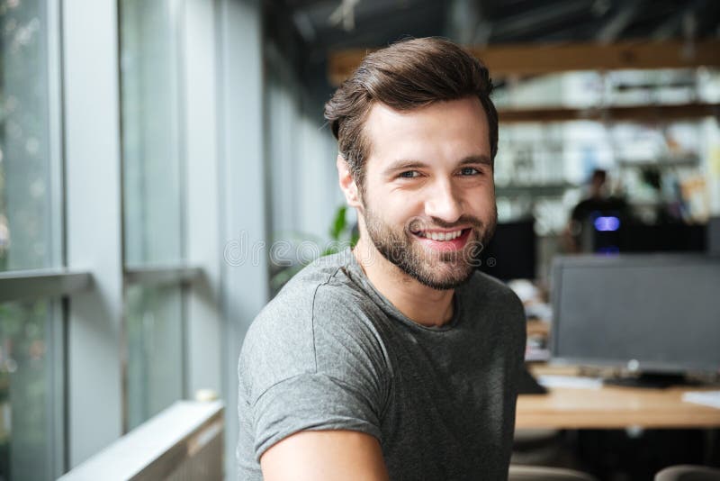 Handsome Smiling Young Man Sitting in Office Coworking. Stock Photo ...
