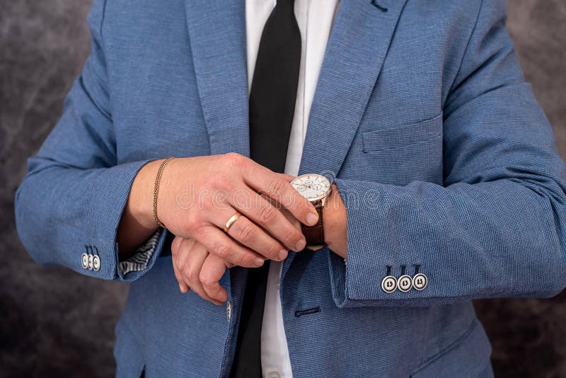 A Handsome Solid Man in a Chic Suit Looks at an Expensive Handsome ...