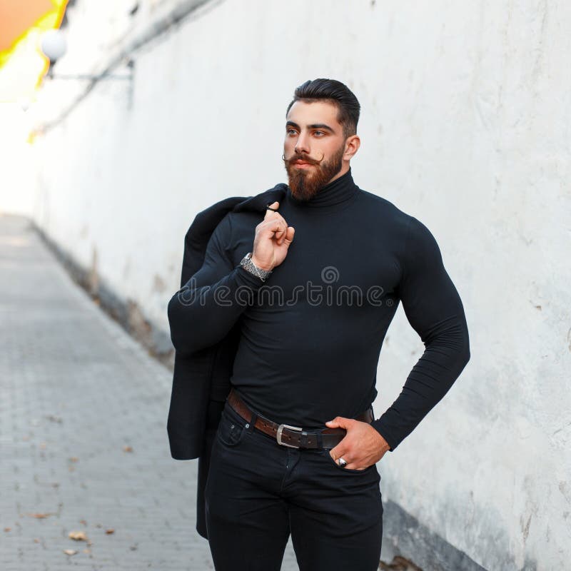 Handsome Strong Man with a Beard in Black Stylish Clothes Posing Stock ...