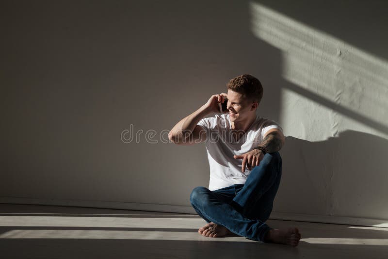 A Handsome Strong Young Man Talks on a Smartphone Business Stock Image ...