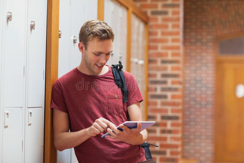 Handsome Student Leaning Against Lockers Using Tablet Stock Photo ...