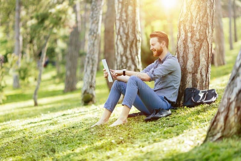 Handsome Student Reading in Nature Stock Photo - Image of cheerful ...