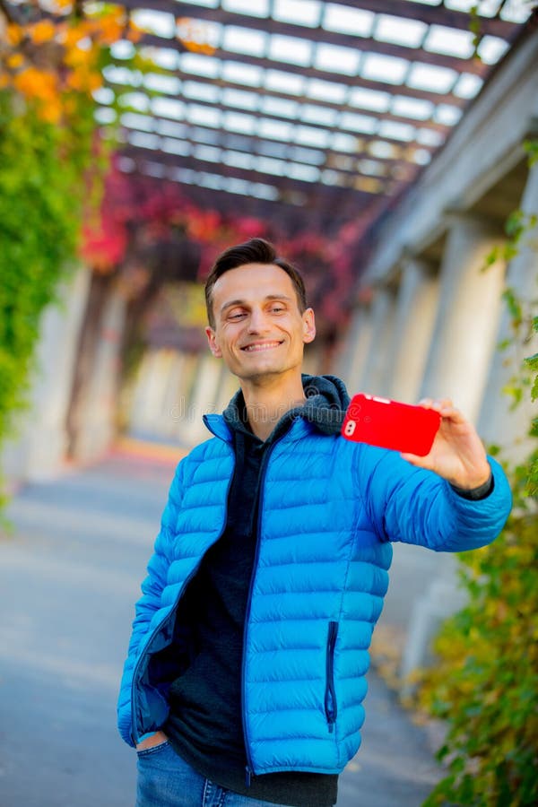 Handsome Tall Man in Blue Jacket with Mobile Phone Stock Image - Image ...