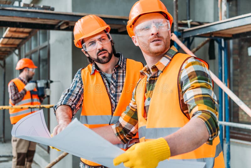 Handsome Thoughtful Builders with Blueprint Stock Image - Image of ...